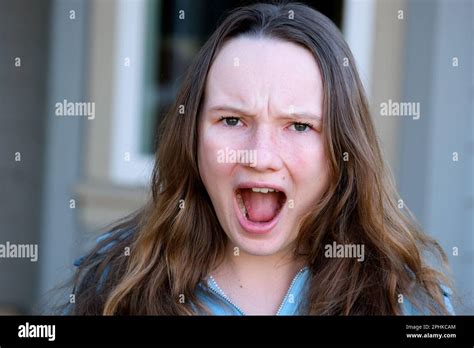 Angry Dissatisfied Teenage Girl Screaming Loudly With Mouth Open Frown