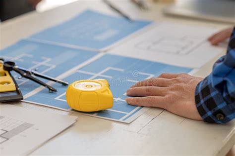 architects are reviewing building plans and correcting errors