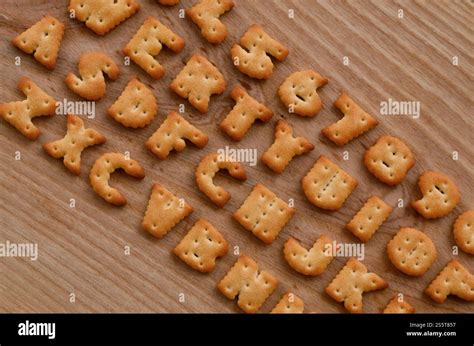 Letters Of Salty Crackers Lay On A Wooden Brown Surface In The Order Similar To The Layout Of