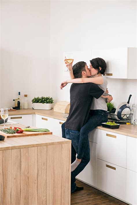 Couple Kissing In The Kitchen By Stocksy Contributor Danil Nevsky Stocksy