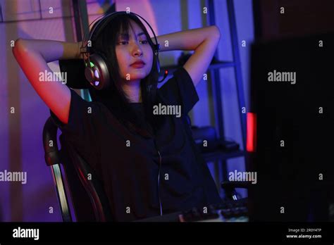 Female Cyber Hacker Gamer Holds Hands Behind Head To Resting After