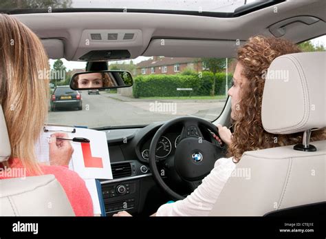 Teenage Girl Holding L Learner Plate With Instructor Passes Driving