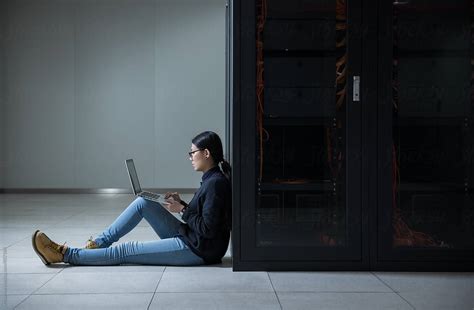 Female Technician Using Computer In Data Center By Stocksy Contributor MaaHoo Stocksy