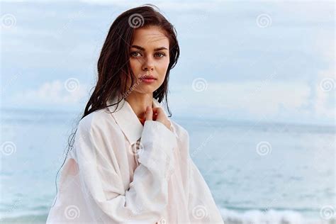 Portrait Of A Beautiful Pensive Woman With Tanned Skin In A White Beach