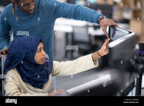 Black Muslim Female Software Developer Working Together With Her