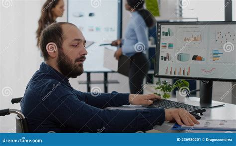 Invalid Worker With Disabilities Working At Computer Stock Image