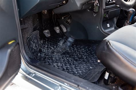 드라이 클리닝 전에 세부 차량에 대한 작업장에서 가스 페달과 브레이크와 검은 색 고무의 더러운 자동차 바닥 매트 자동차 서비스 산업 세단의 인테리어 매트 실내 장식에 대한