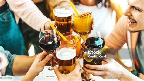 바 레스토랑에서 칵테일 잔을 들고 있는 손의 클로즈업 이미지 주말에 즐거운 시간을 보내는 젊은이들 함께 술을 마시는 남자와 여자가 있는 음식과 음료 컨셉 단체에 대한 스톡