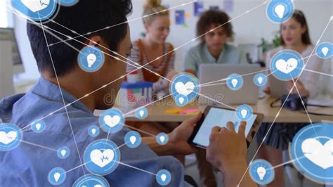 Animation Of Network Of Connections With Icons Over Diverse Business People In Office Stock