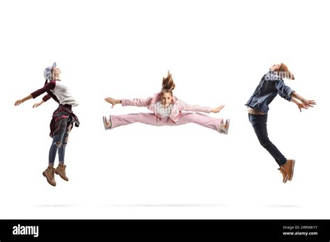 Girl Leaping In The Air Between A Male And Female Dancers Isolated On