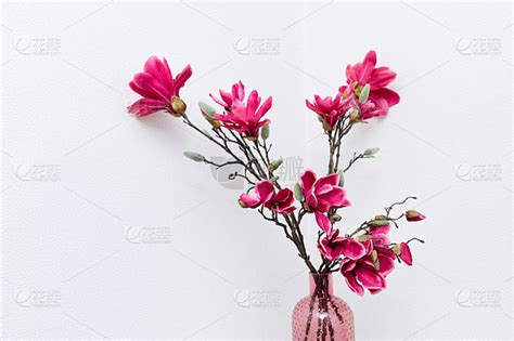 一束粉红色的花插在白色的花瓶上
