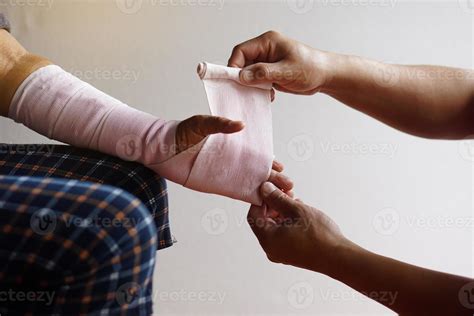 Closeup Hands Wrapping Patients Sprained Wrist With Elastic Bandage