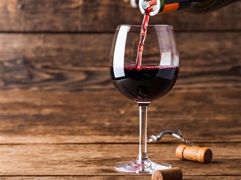 Premium Ai Image Pouring Red Wine Into A Wine Glass With Decanter Or