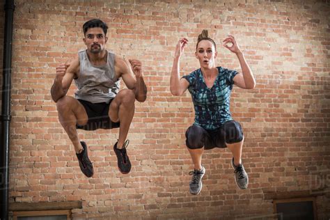 Man And Woman Jumping In Gym Royalty Free Stock Photo Dissolve