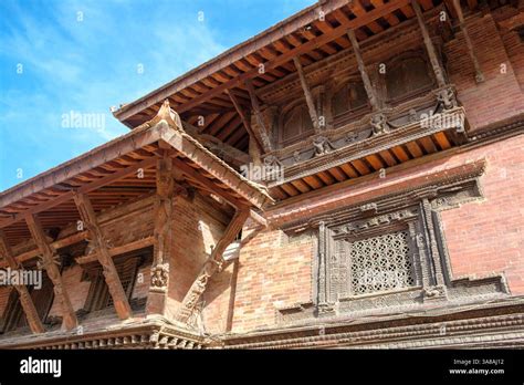 Traditional Newari Architecture In Nepal Featuring Elaborate Wood Carvings On Windows And Roof