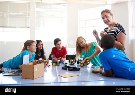 Students In After School Computer Coding Class Building And Learning To