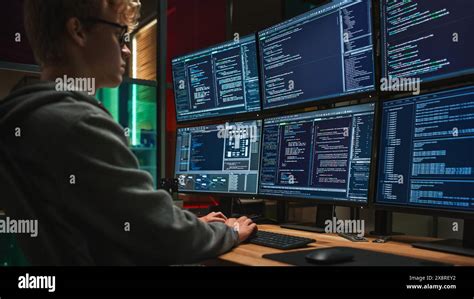 Young Caucasian Man Writing Code On Professional Six Monitors Setup In
