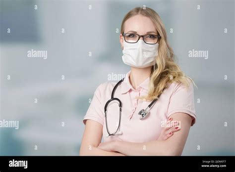 Female Doctor With Stethoscope Protected By Medical Face Mask In Front Of A Clinic Room Stock
