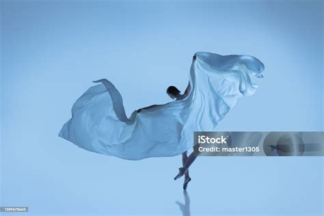 유연한 여성의 초상화 직물로 춤추는 우아한 발레리나 파란색 스튜디오 배경에 고립 된 천 은혜 예술 아름다움 개념 무중력 부드러움