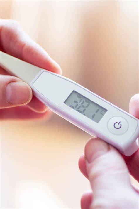 A Person Is Holding A Thermometer Reading 361 Degrees Celsius Stock