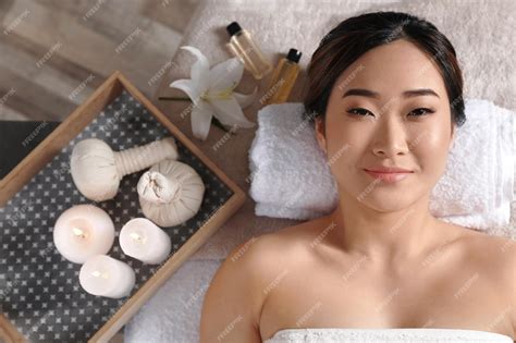 Premium Photo Beautiful Asian Woman Lying On Massage Table In Salon