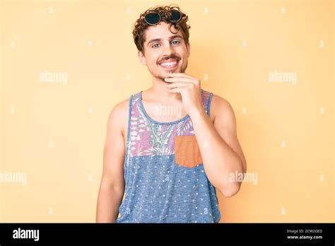 Young Caucasian Man With Curly Hair Wearing Casual Style With