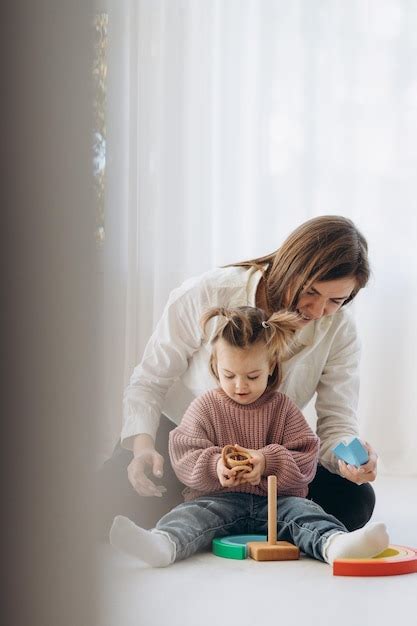 Premium Photo The Girl Learns Colors By Playing With Wooden
