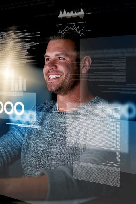 Watching His Code In Action Shot Of A Smiling Computer Programmer Working At His Computer Late