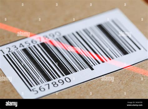 Parcel With Label Closeup Red Laser Light On Barcode For Scanning Stock Photo Alamy