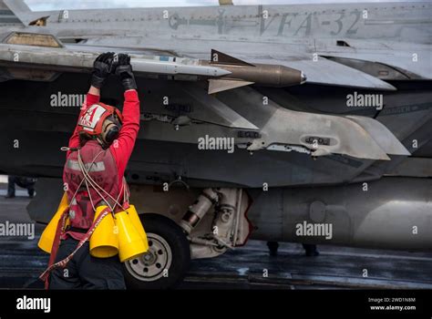 Aviation Ordnanceman Arms Ordnance On An Fa 18 Super Hornet Stock