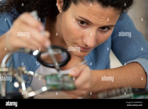 Woman Soldering Elements Of Circuit Board Stock Photo Alamy