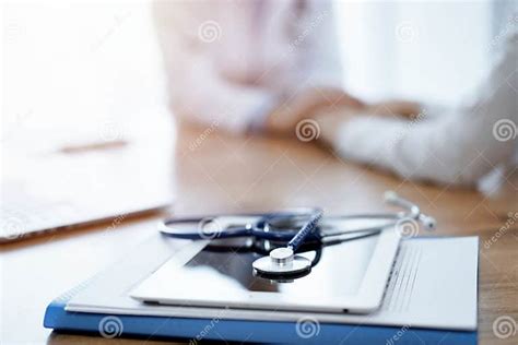 Stethoscope Tablet And Laptop Computer Are Lying On The Wooden Table
