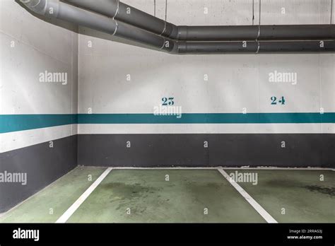 An Empty Underground Car Park Delimited By White And Green Paint On The