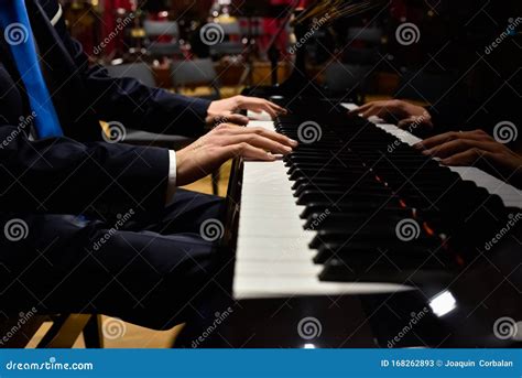 Male Pianist Playing Classical Music On A Grand Piano Stock Image
