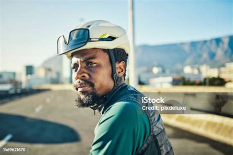 흑인 남성 자전거 운동 선수 및 사이클링 훈련 운동 및 피트니스의 도시 거리 아침에 헬멧과 장비에 초점을 맞춘 도로에서 자전거 타는 사람과 함께하는 도시 자전거 스포츠 및