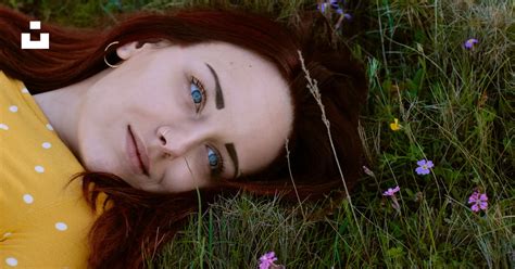 갈색과 흰색 물방울 무늬 상의를 입은 여자가 낮에 푸른 풀밭에 누워 있습니다 사진 Unsplash의 무료 여자 이미지