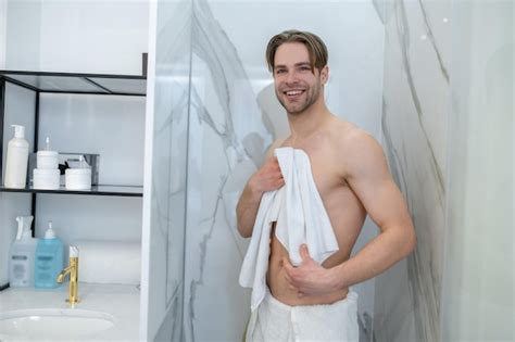 Premium Photo After Shower Well Built Young Man Drying Himself With
