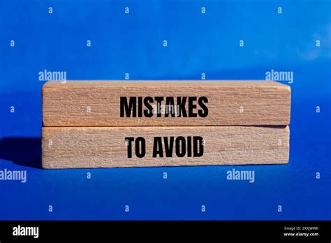 Mistakes To Avoid Message Written On Wooden Blocks With Blue Background