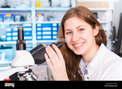 MODEL RELEASED Female Lab Technician Using Microscope Stock Photo Alamy