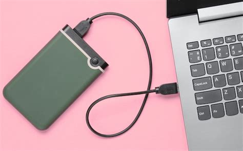 Premium Photo External Hard Drive Connected To Laptop On Pink