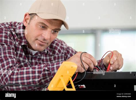 Man Measuring The Voltage Of A Machine Stock Photo Alamy