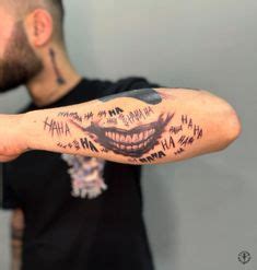Embrace A Playful Spirit With A Joker Ha Ha Tattoo On Your Outer Arm