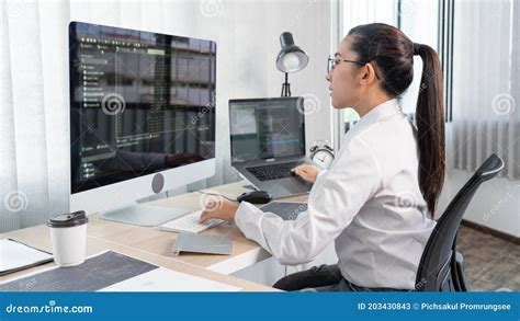 Young Asian Woman Programmer Typing Code Working With Computer At Table Coding Cyberspace And