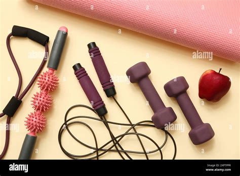 Apple And Different Sports Equipment On Beige Background Stock Photo