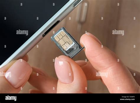 Woman Inserting Sim Card Into Mobile Phone Closeup Stock Photo Alamy