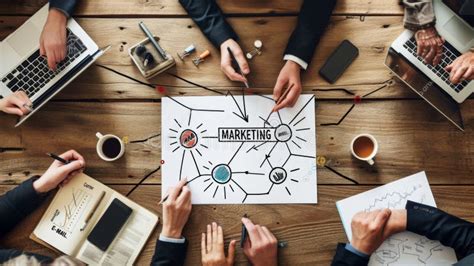 Group Of People Is Engaged In A Collaborative Brainstorming Session Around A Table Covered With