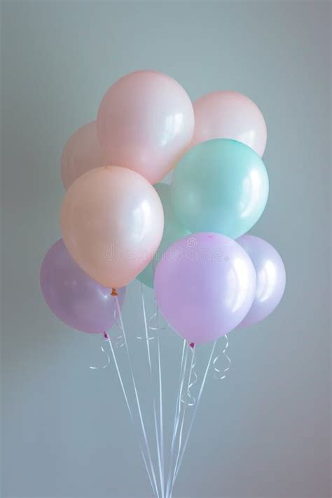 Colorful Pastel Balloons Cluster Against Light Grey Background Stock