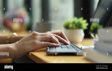 Side View Of Female Hands Typing On Wireless Keyboard On Wooden Bar In Cafe Stock Photo Alamy