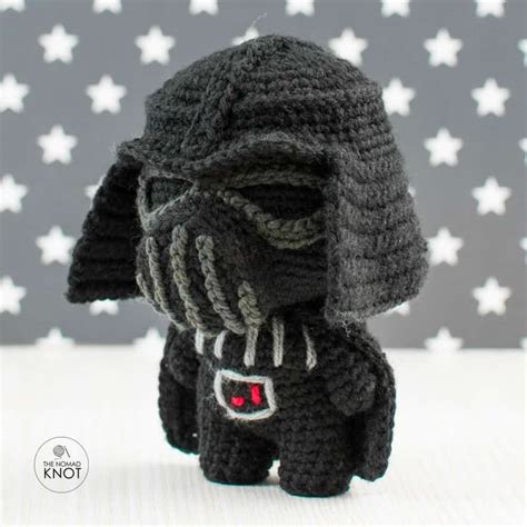A Crocheted Darth Vader Toy Is Shown In Front Of An American Flag Background