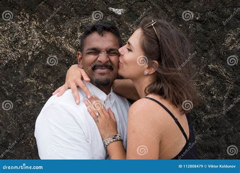 Outdoor Portrait Of Romantic Kissing Young Couple In Sandy Beach Stock